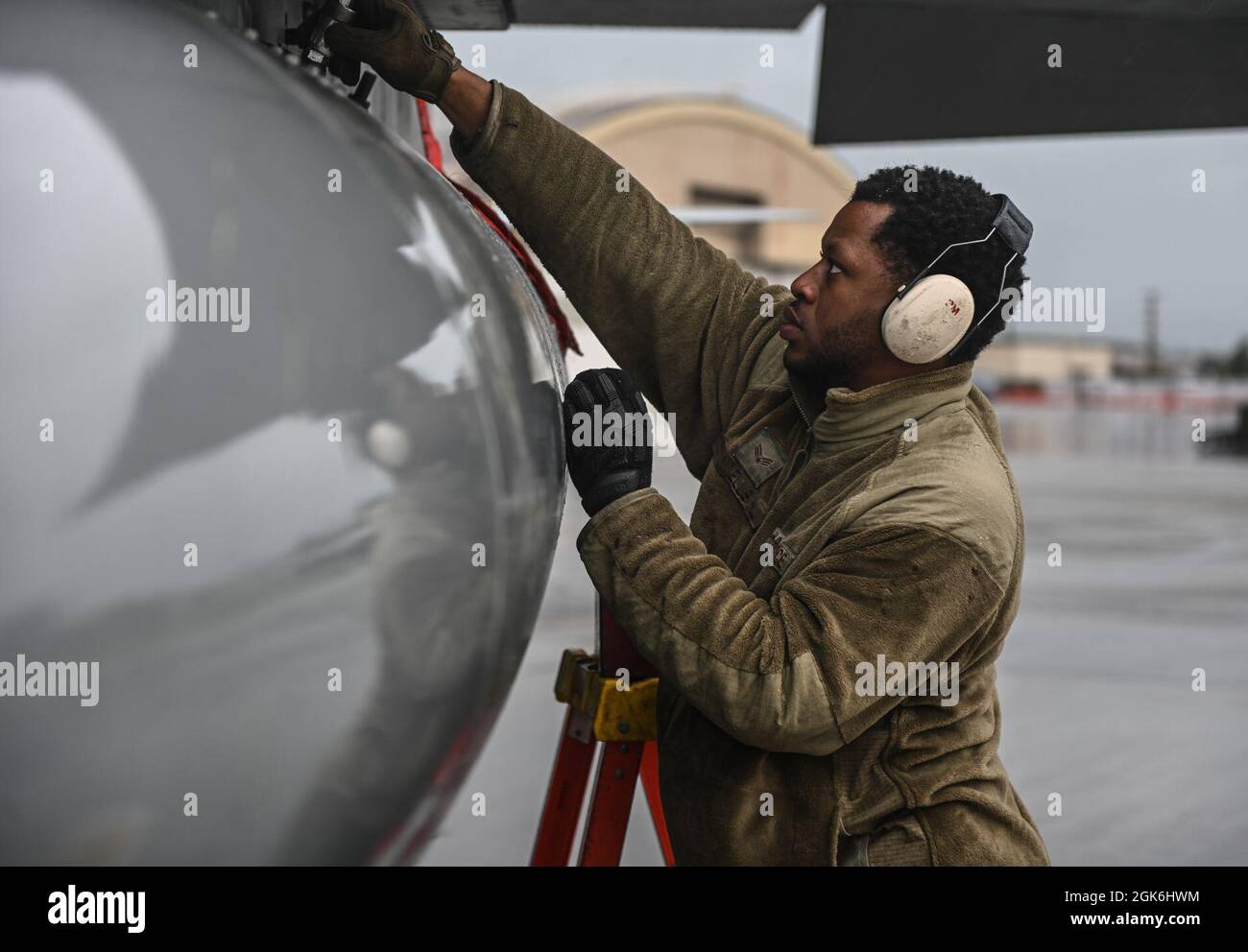 A U.S. Air Force Airman performs pre-flight checks on an F-16C Fighting ...