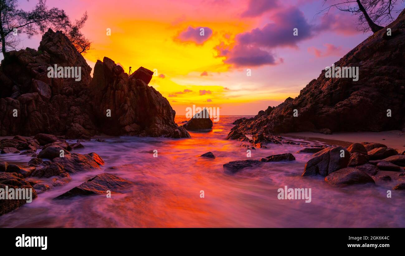 Long exposure image of Dramatic sky seascape with rock in sunset scenery background Amazing ...