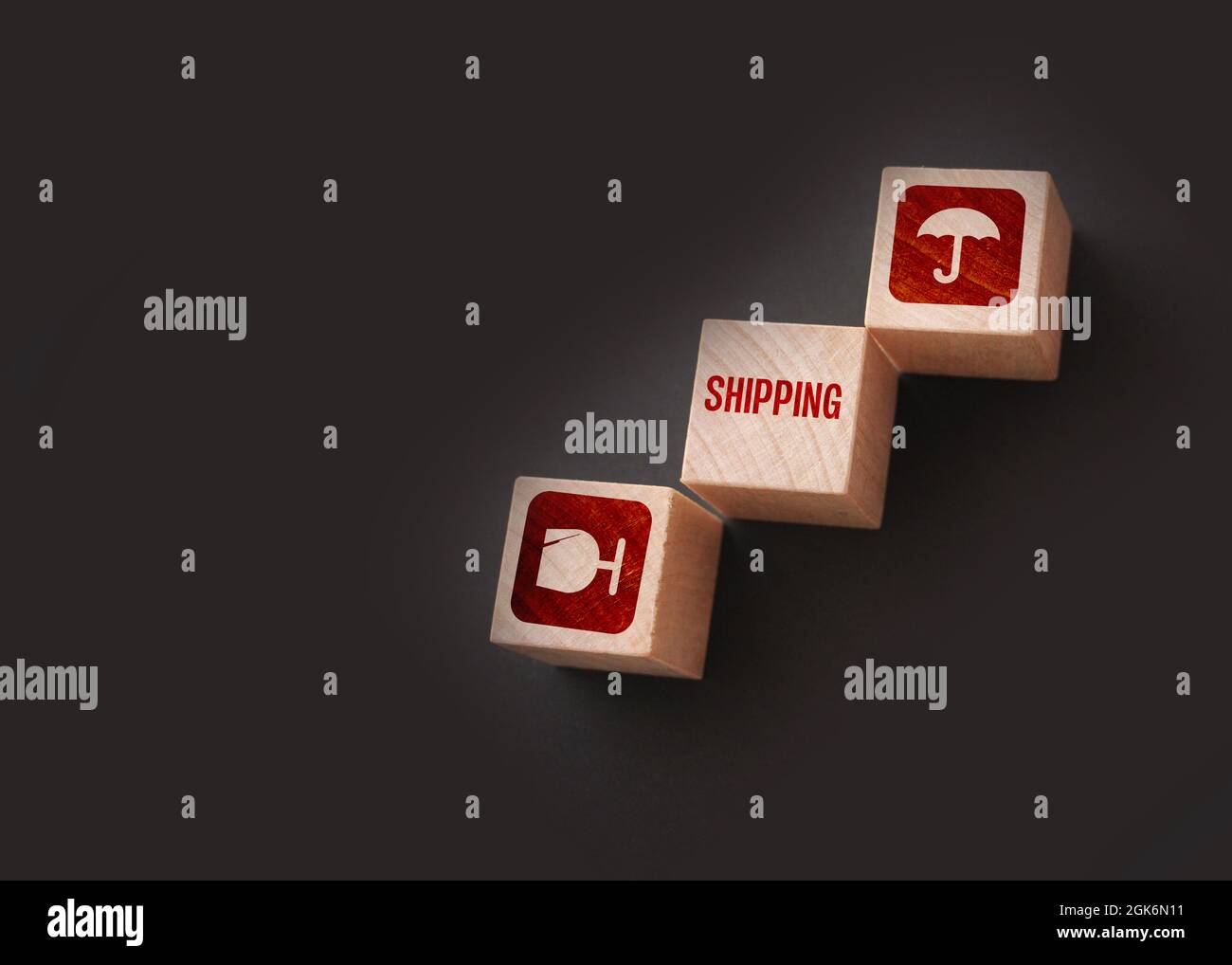 Shipping word and icons engraved on a wooden cubes, isolated on black ...