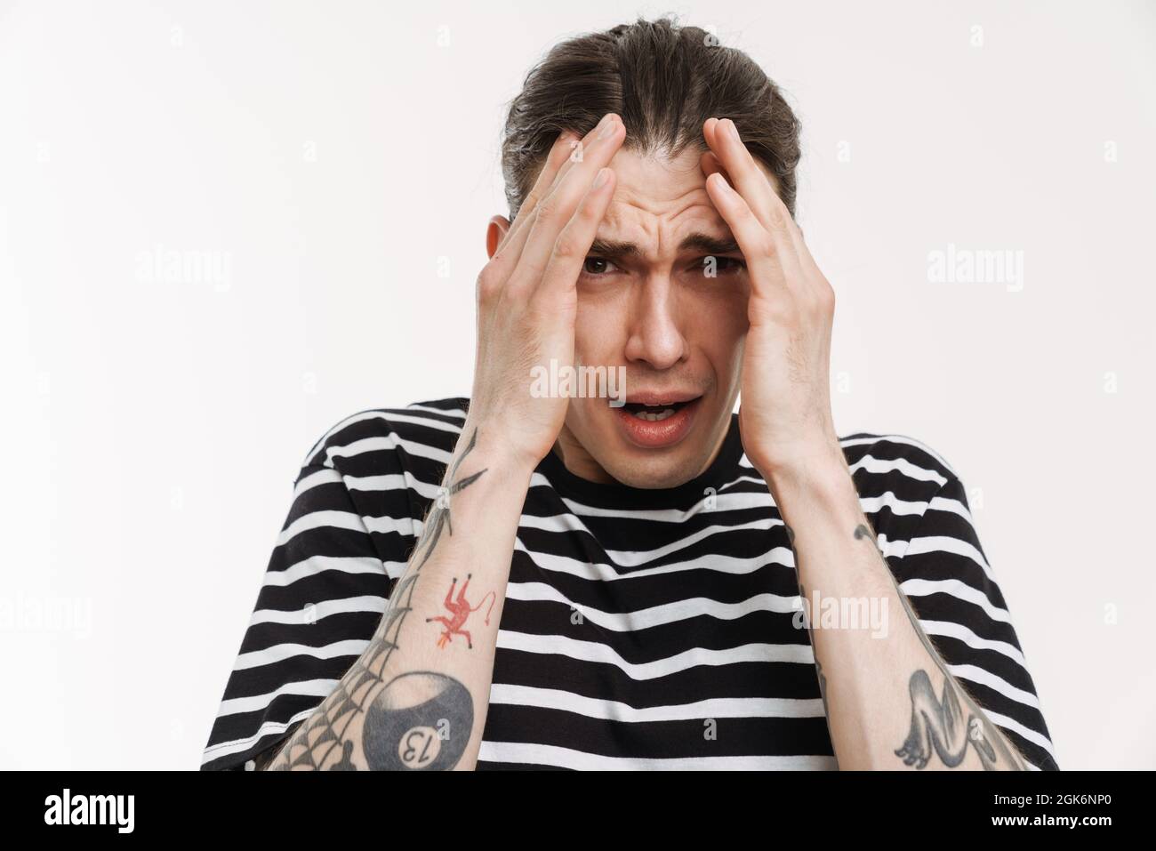 Young white scared man covering his head and looking at camera isolated ...