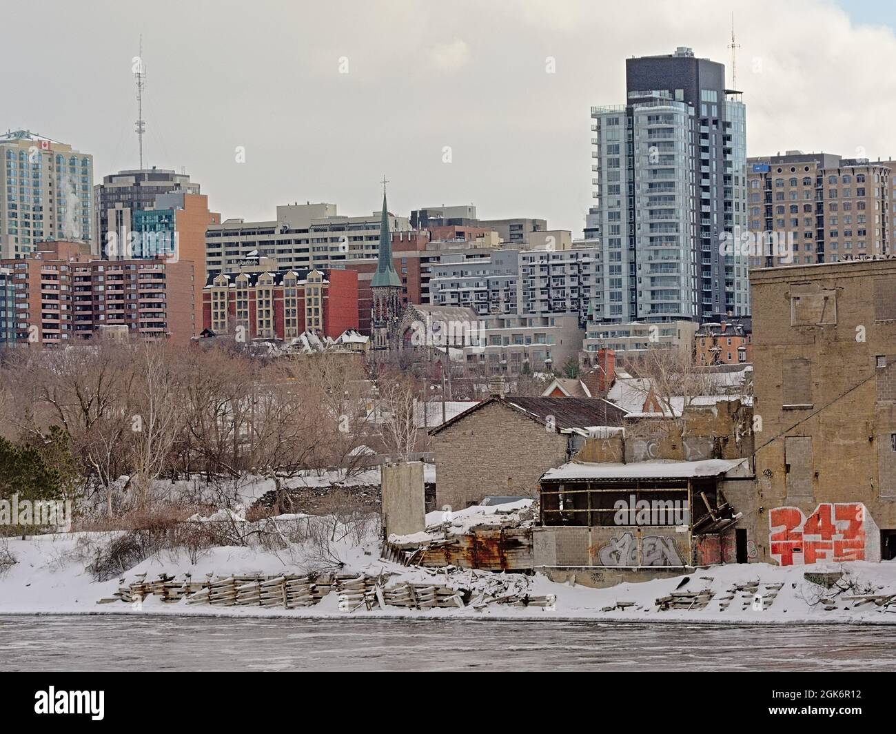 Embankment of Ottawa river with old industrial buildings, church and ...