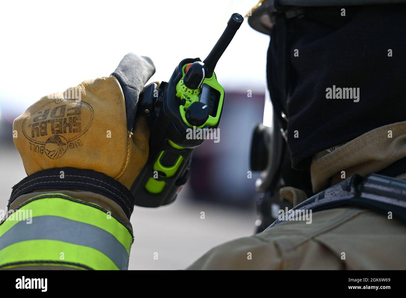 A Kirtland Air Force Base firefighter uses radio communication during a ...