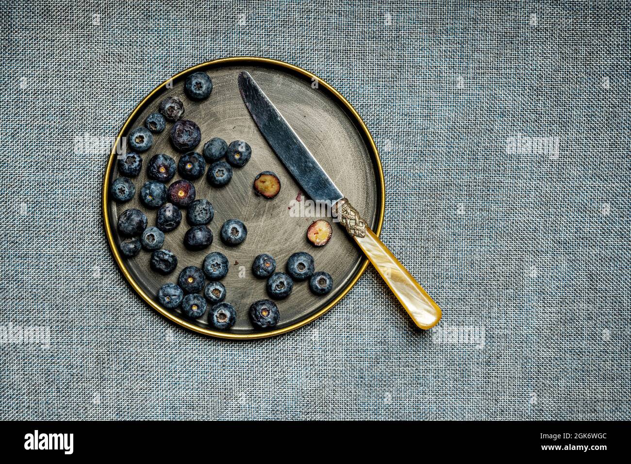 Top view image of ripe blueberries on a vintage metallic circular plate ...