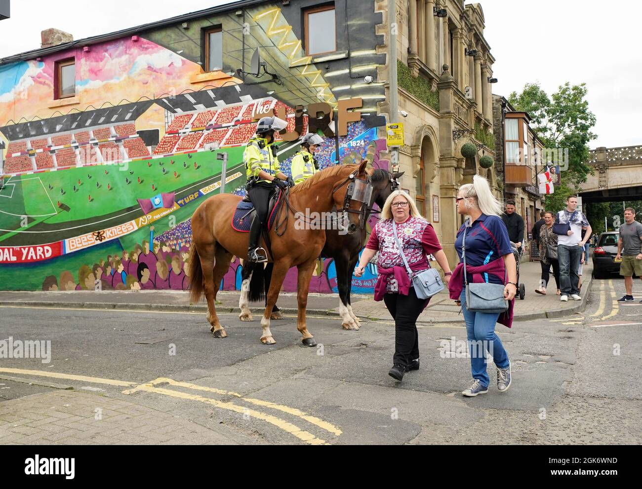 Burnley fans walks past a. Mural on the wall of the Turf pub outside ...
