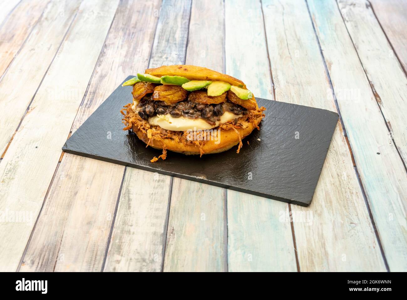 Venezuelan shredded chicken arepa with fresh cheese, ripe banana ...