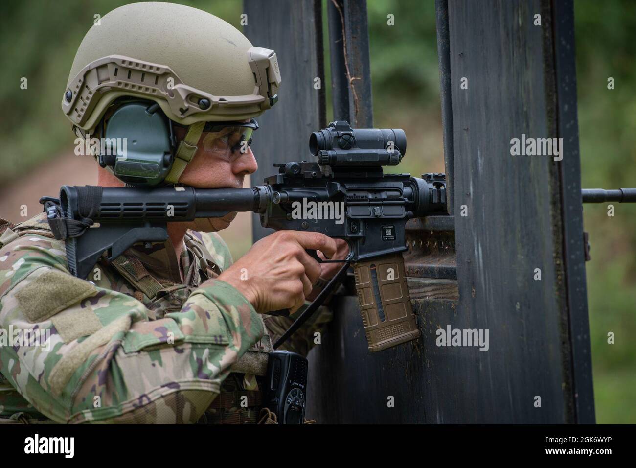 Tech. Sgt. Dedrick Baublitz, 103rd Security Forces Squadron, aims a M4 ...