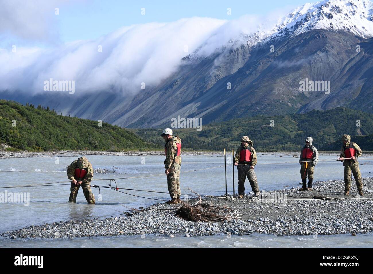 Students in the Basic Military Mountaineering Course assist in holding ...