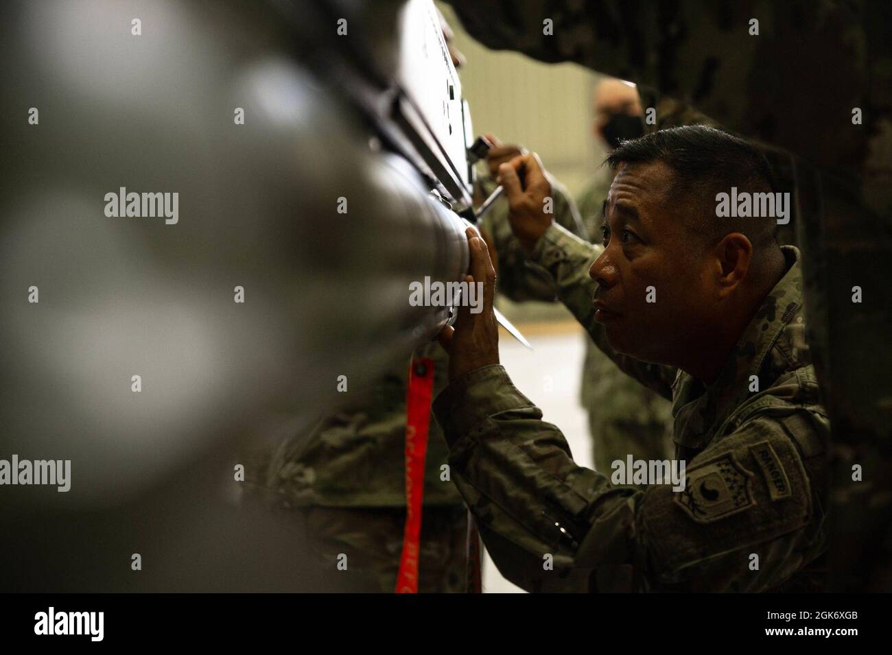 Command Sergeant Major Walter Tagalicud inspects a munition at Osan Air ...