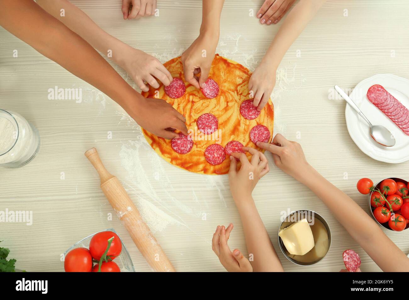 Group of children preparing pizza during cooking classes Stock Photo ...