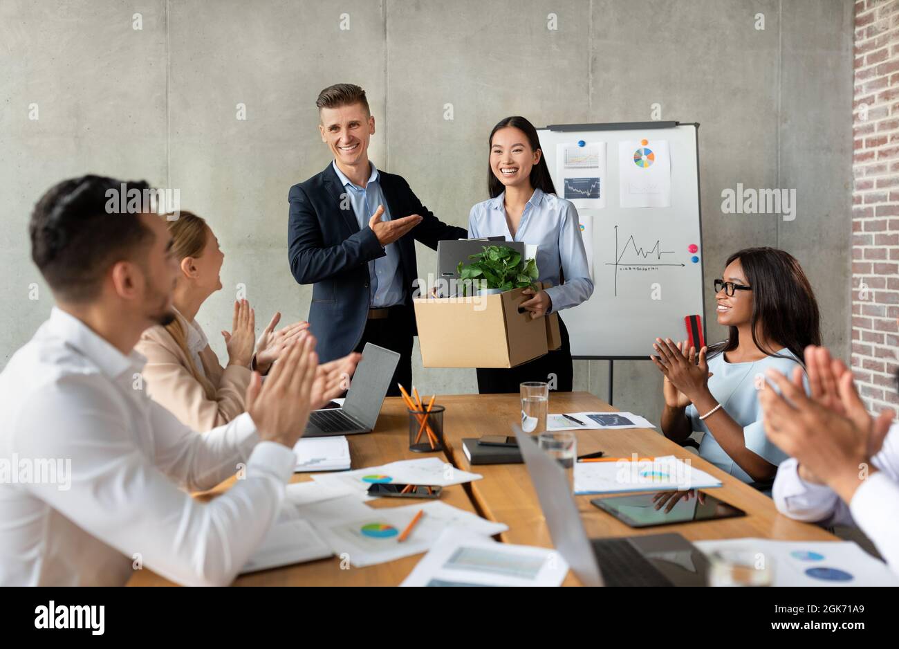 Smiling HR Manager Introducing New Female Employee To Colleagues During ...