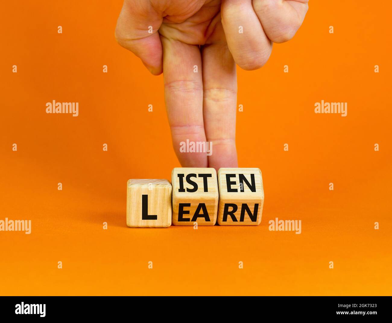 Listen and learn symbol. Businessman turns wooden cubes and changes a ...