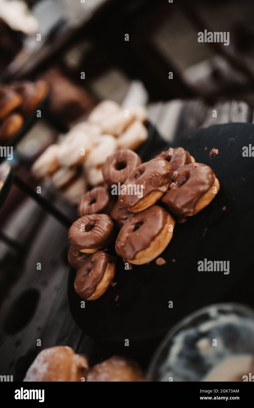 Vertical closeup of a stack of chocolate donuts Stock Photo - Alamy