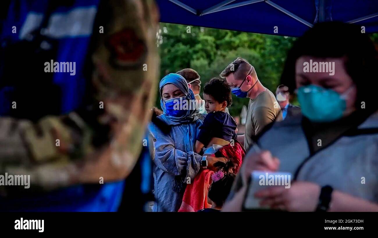 A family of Afghan evacuees wait to be medically screened at Ramstein ...
