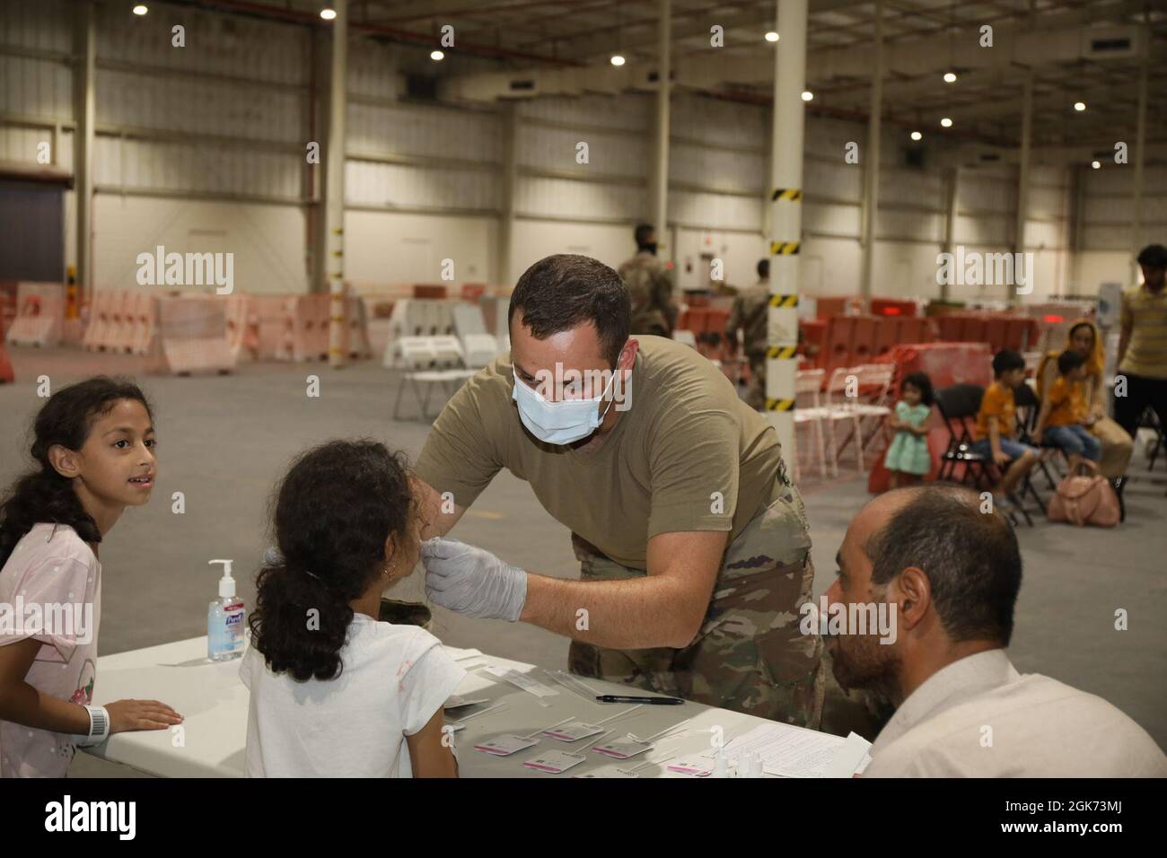Pfc. Logan Taylor, combat medic, 811th Hospital Center, administers a ...