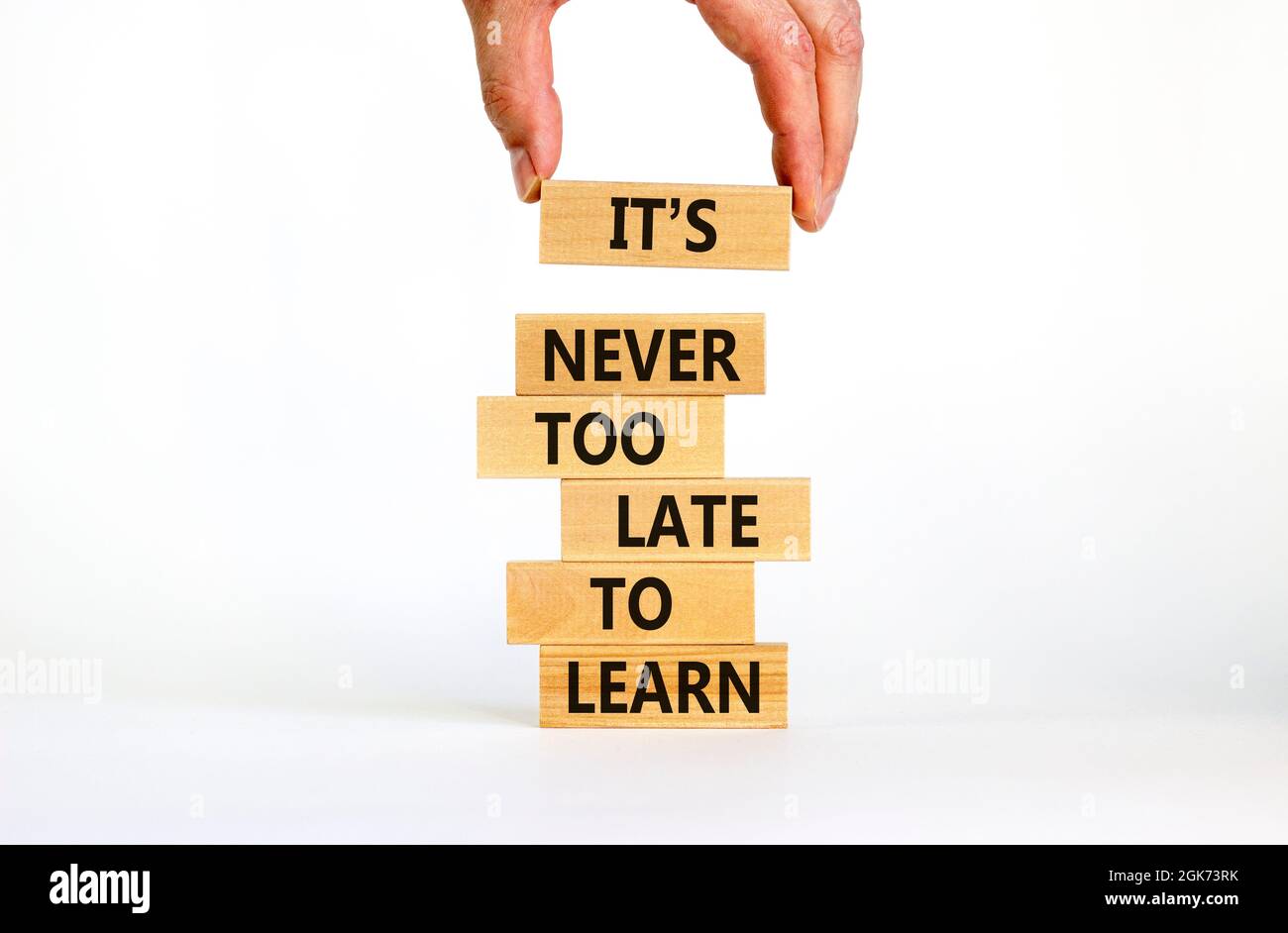 Learn symbol. Wooden blocks with words 'It is never too late to learn ...