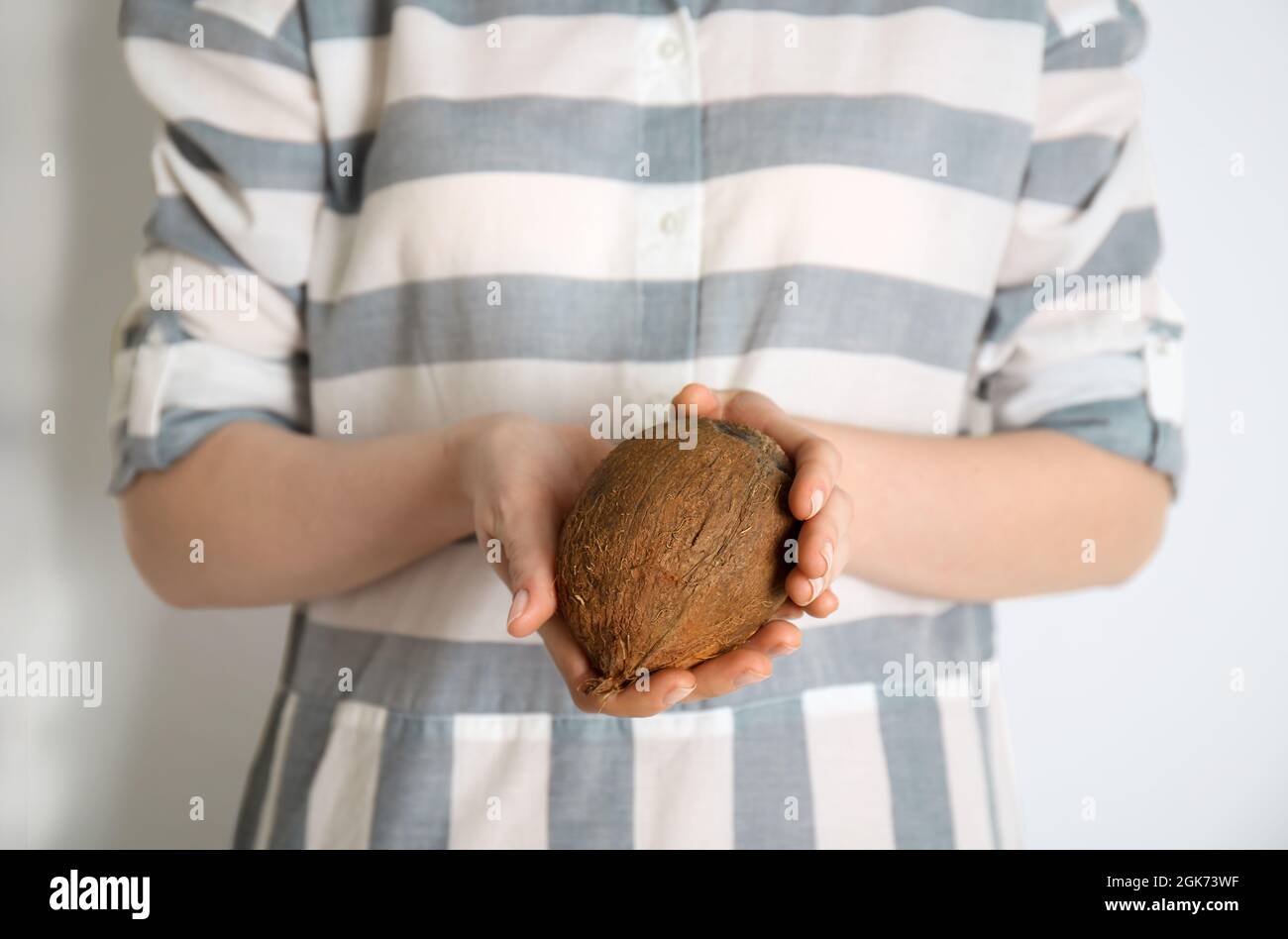 Young woman with coconut on white background Stock Photo - Alamy