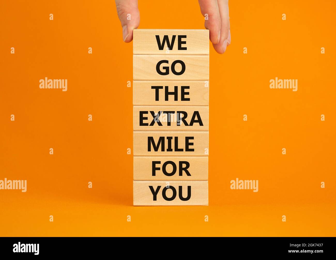 Go the extra mile symbol. Wooden blocks with words 'We go the extra ...