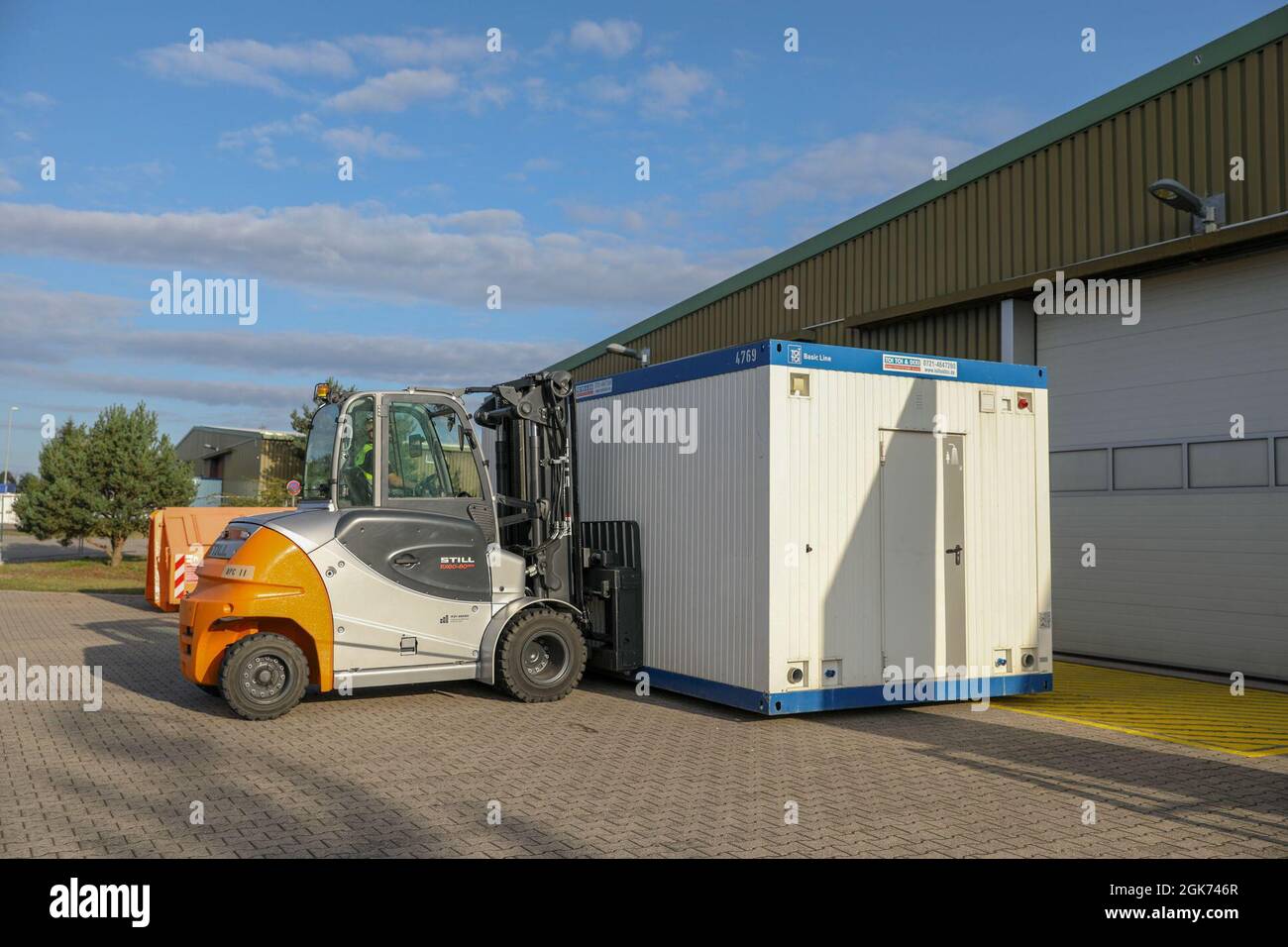 Portable showers and latrines are offloaded at the Deployment ...