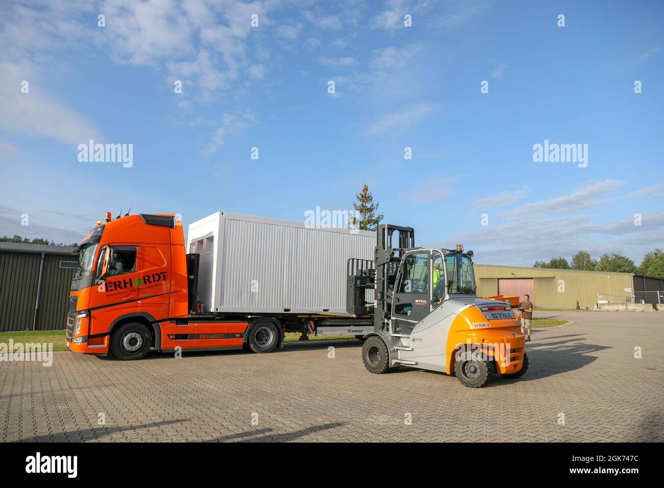 Portable showers and latrines are offloaded at the Deployment ...