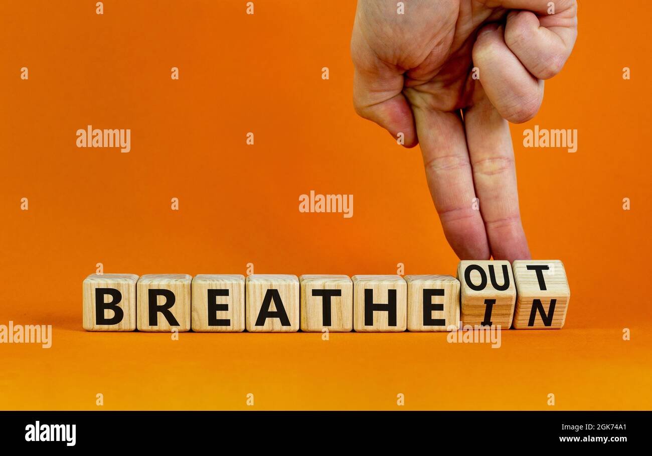 Breathe in and out symbol. Doctor turns cubes, changes words breathe in ...
