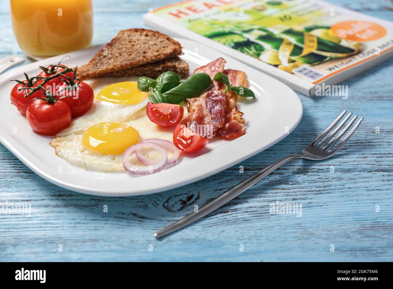 Delicious breakfast with over easy eggs on kitchen table Stock Photo ...