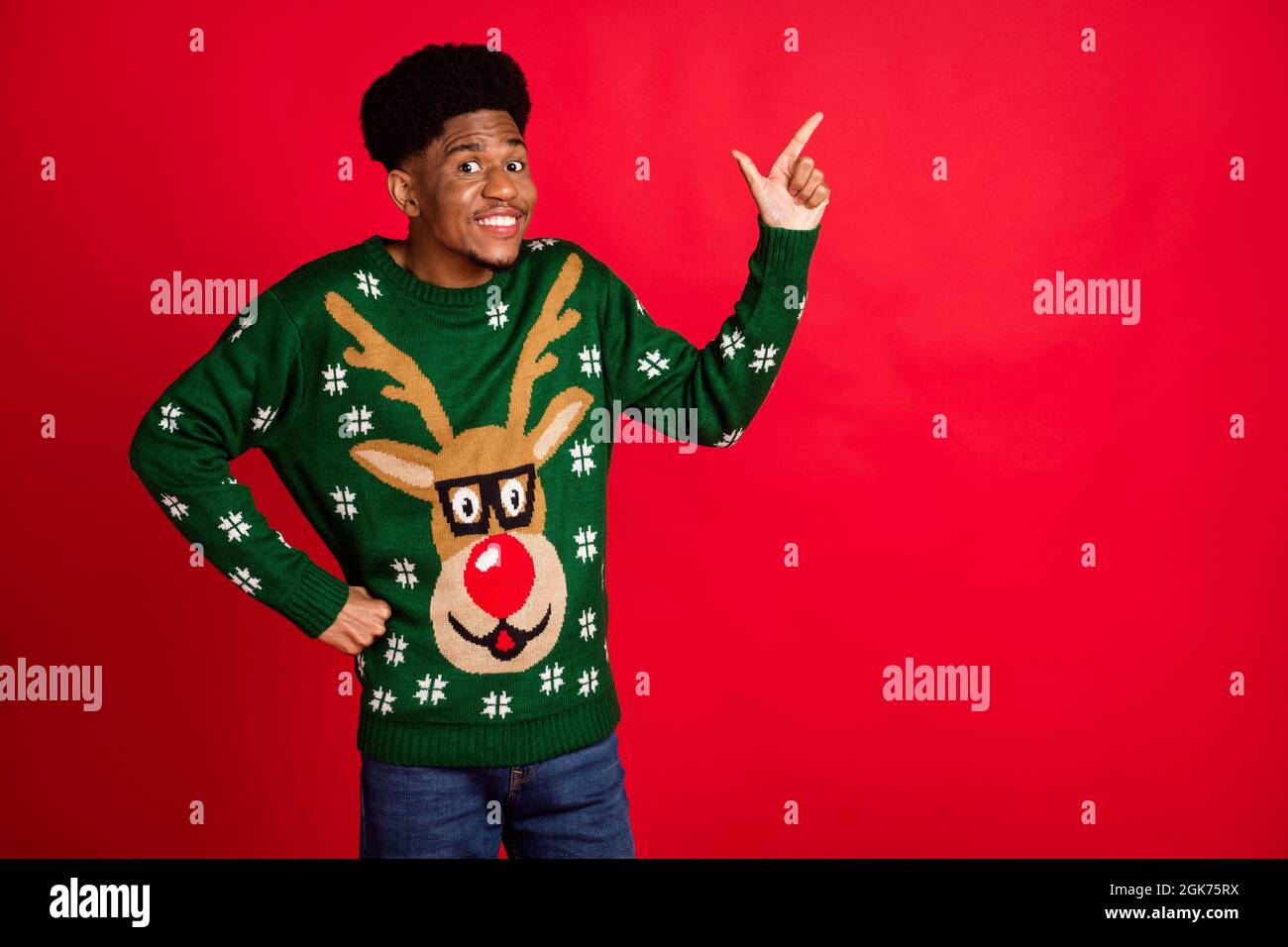 Portrait of attractive cheerful guy wearing ugly jumper demonstrating ...