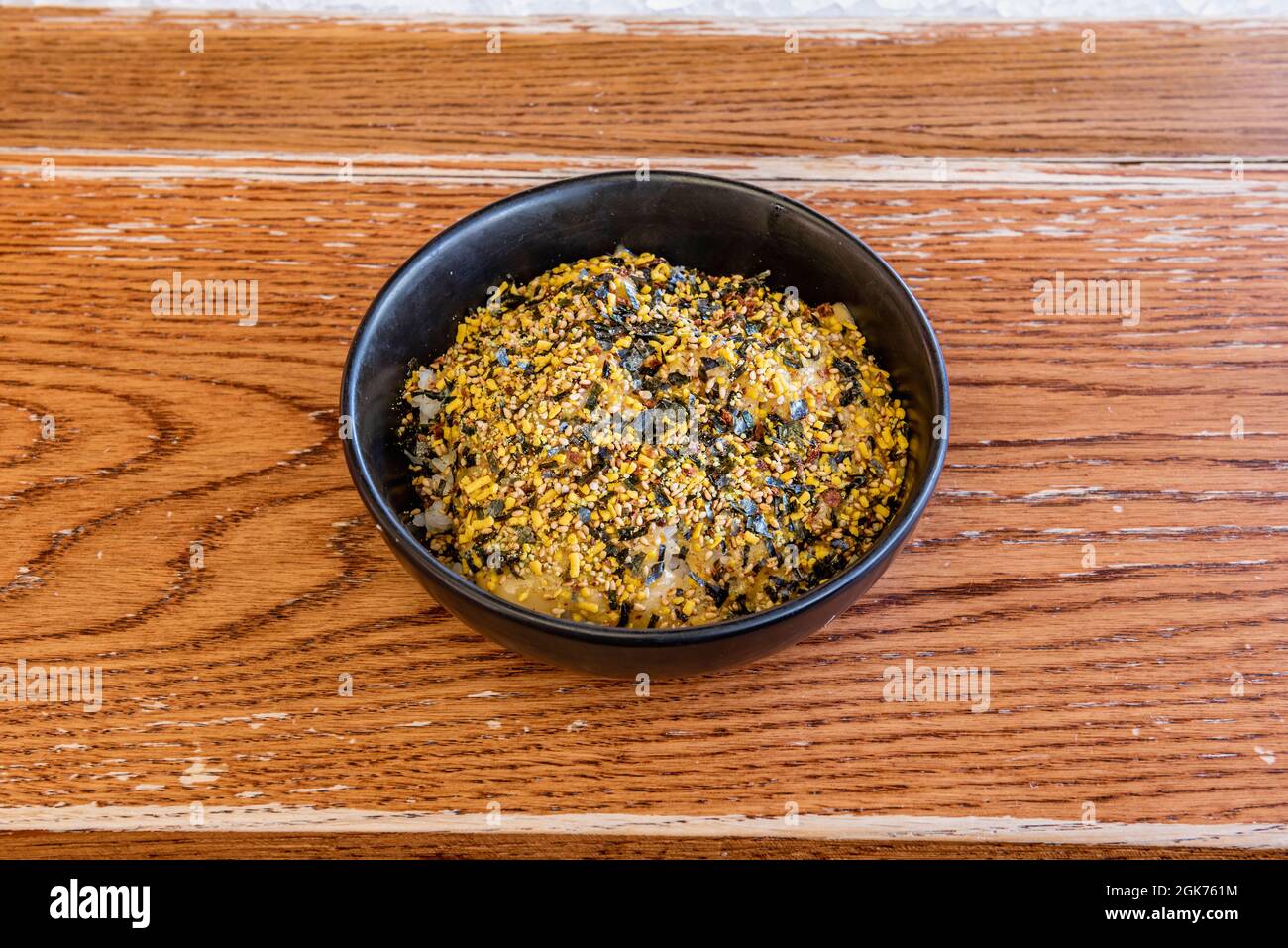 Black bowl of rice cooked with Asian recipe with many seeds of all ...