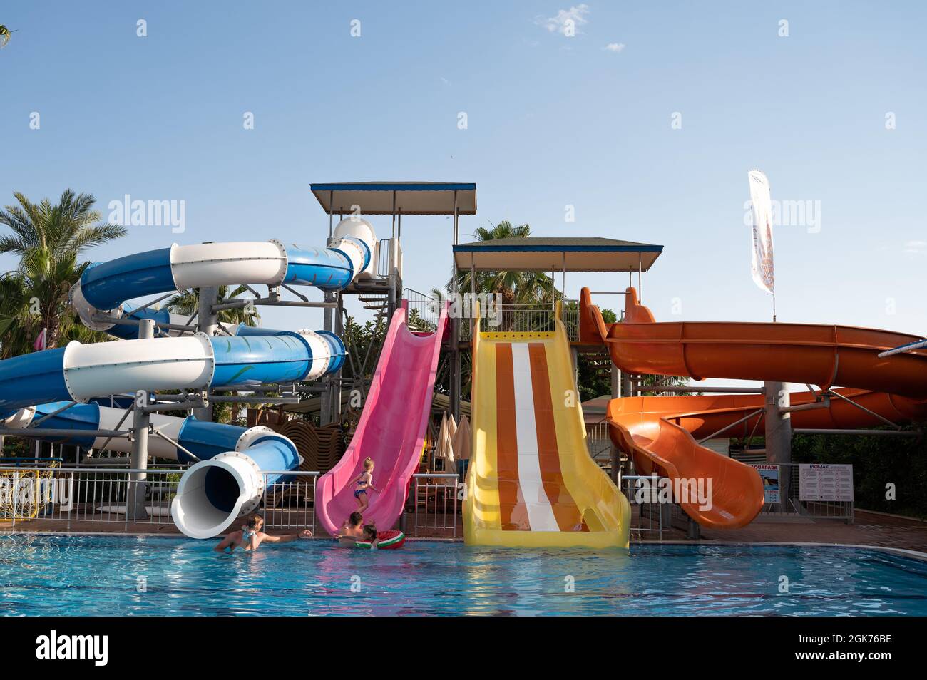 Water park, bright multi-colored slides with a pool. A water park ...
