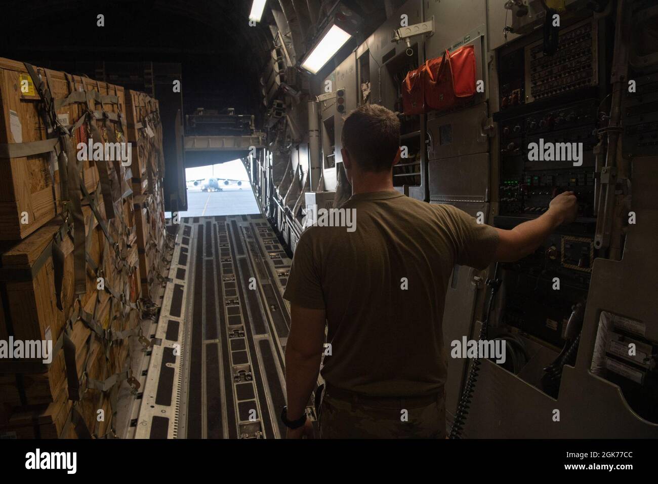 A U.S. Air Force Loadmaster loads cargo bound for Kabul International ...
