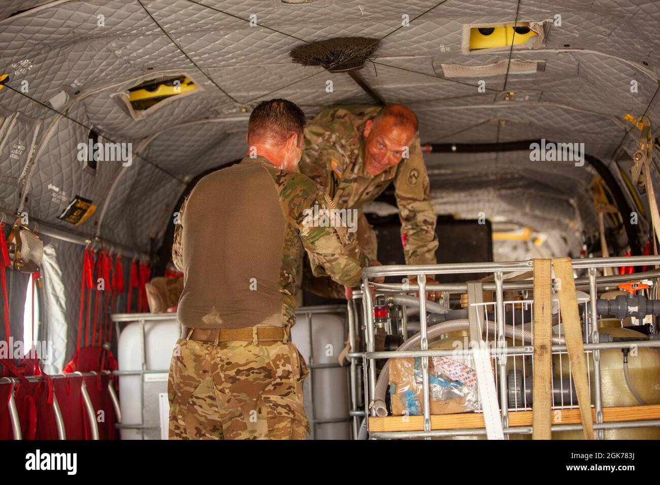 Col. Stephen Gventer, and Sfc. Christopher Durkovic, help load cargo ...