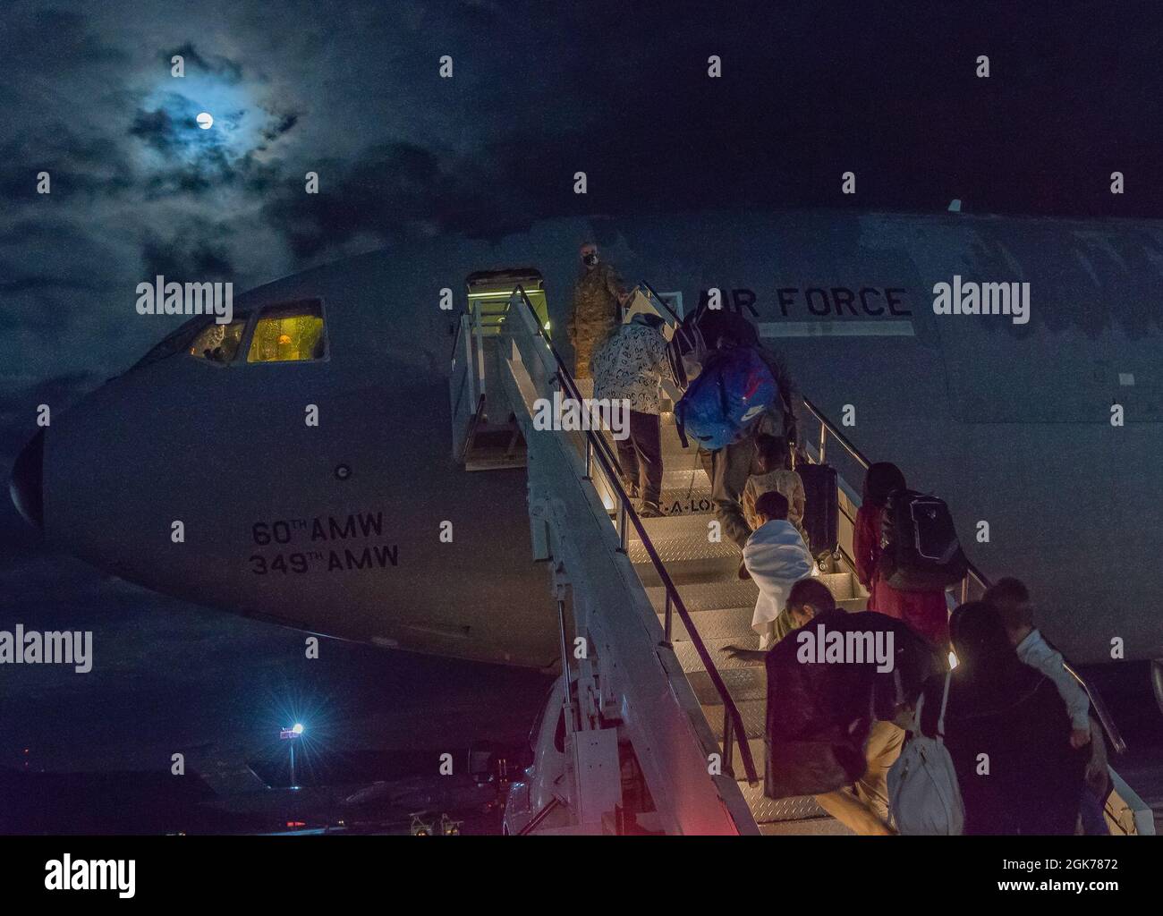 U.S. citizens and their families process through the passenger terminal ...