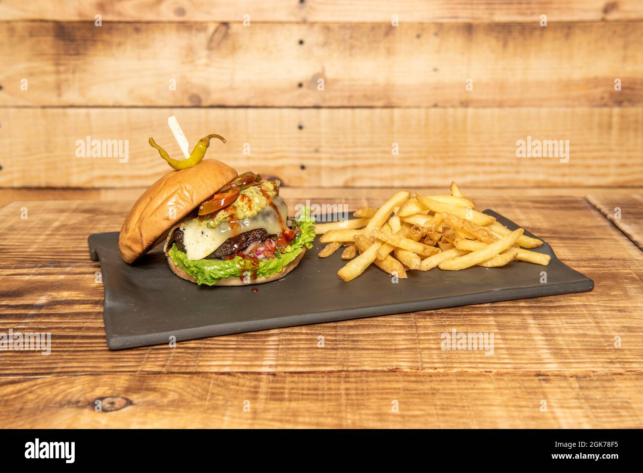 Delicious Mexican style beef burger with melted cheese, jalampeños ...