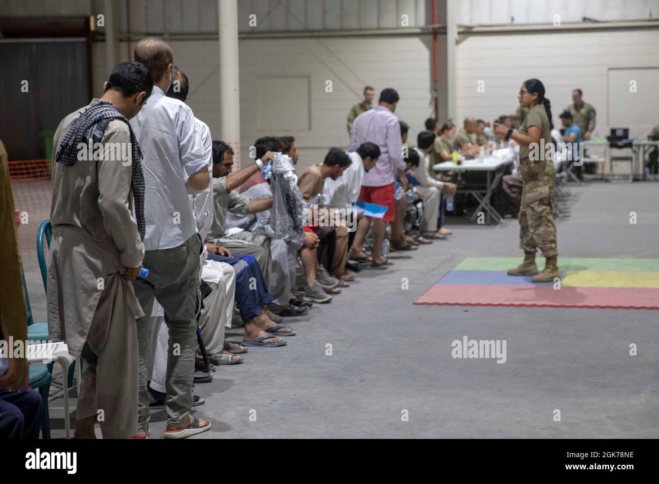 Afghan evacuees line up for biometrics during out-processing at Camp As ...