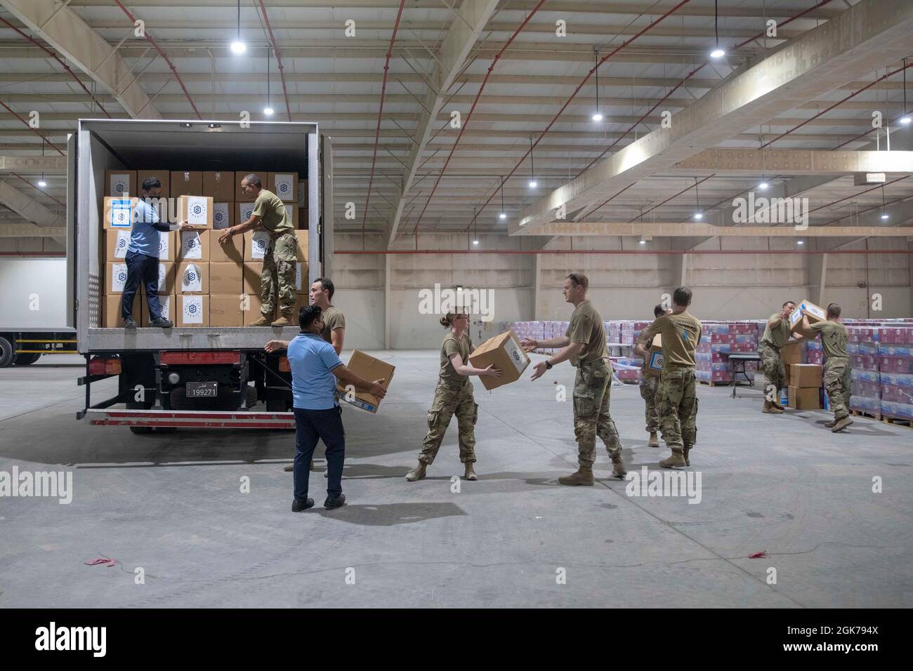 U.S. Army Soldiers and civilian volunteers unload Spirit of America ...