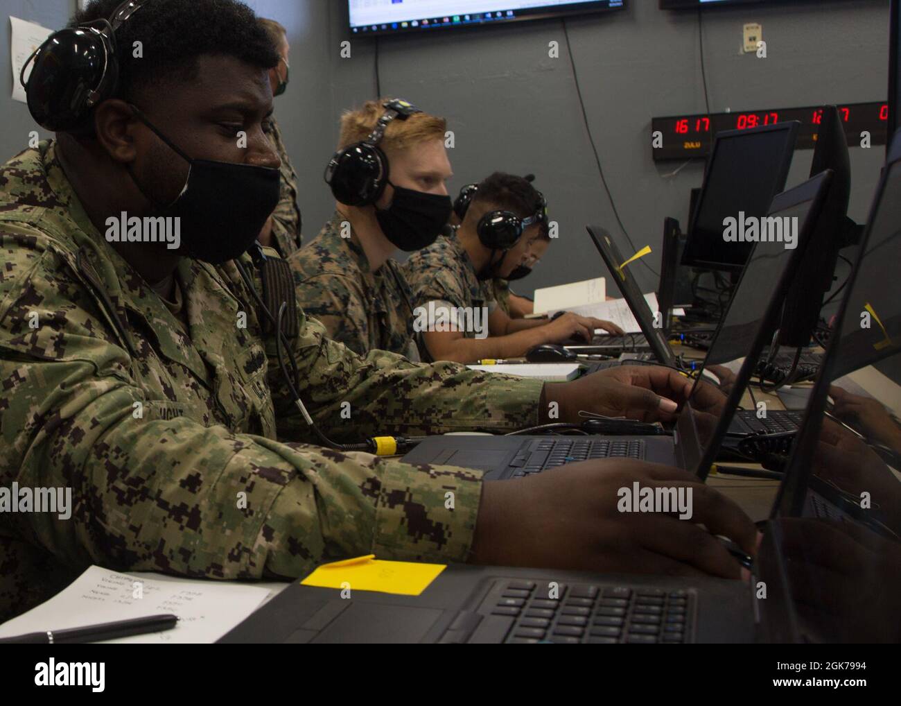 Marines and Sailors work as members of a joint forces simulation hosted ...