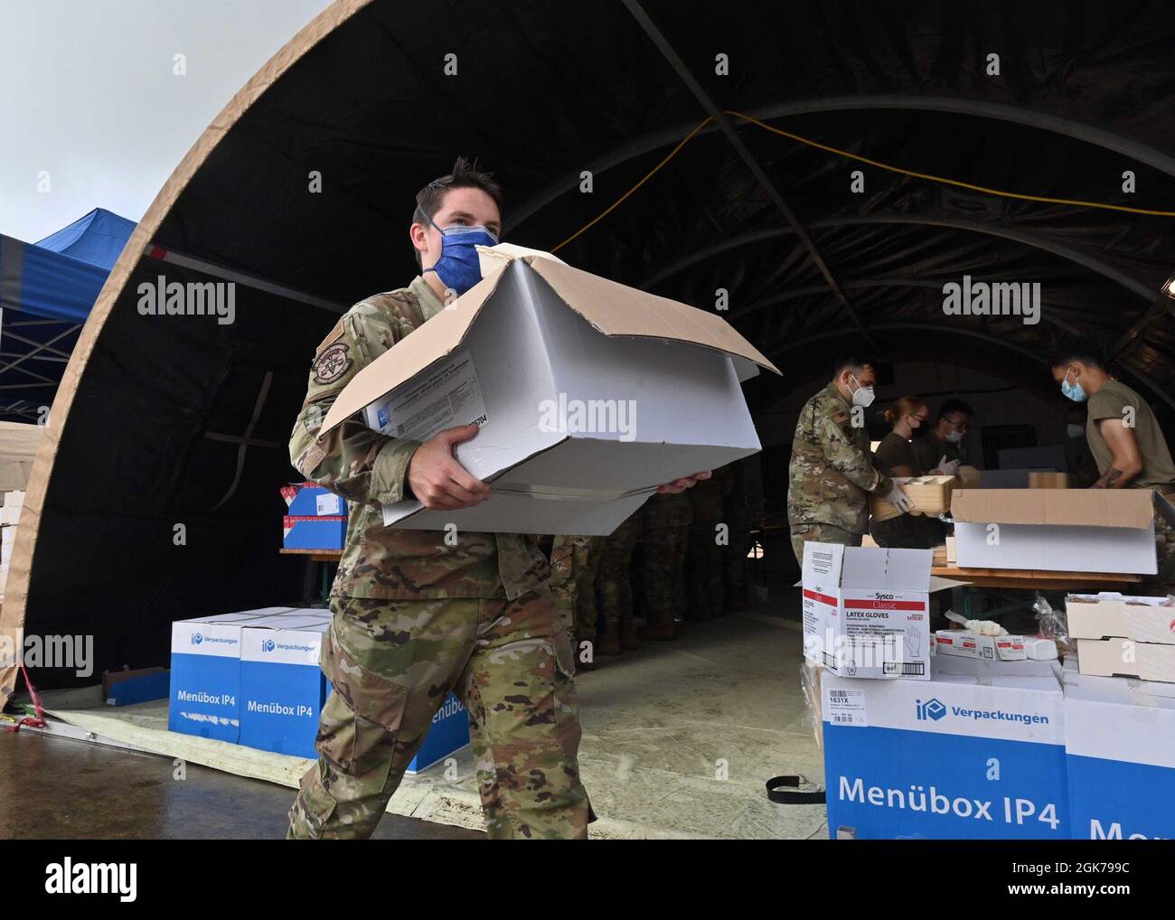 Airmen pack meals and disperse it to evacuees during Operation Allies ...