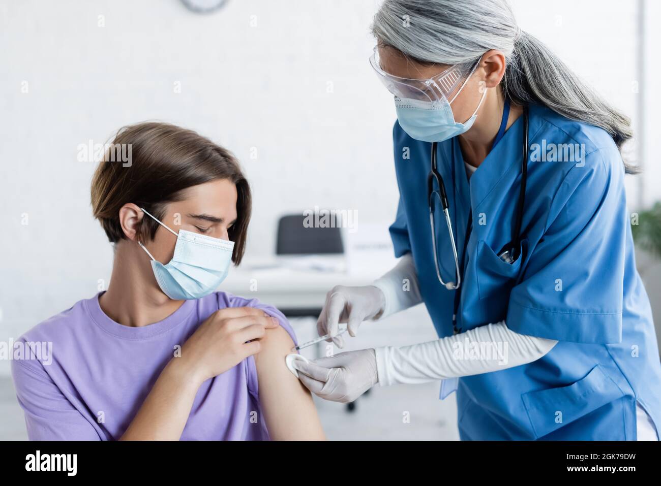 Doctor giving injection young patient hi-res stock photography and ...