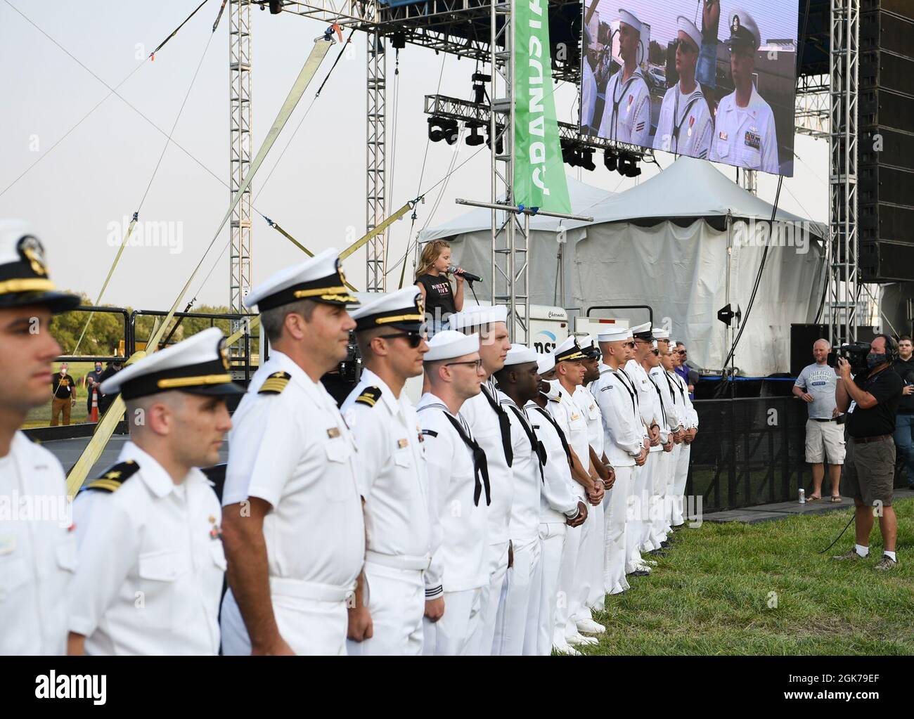 Sailors stand at attention as a citizen of Boise sings at the Western ...
