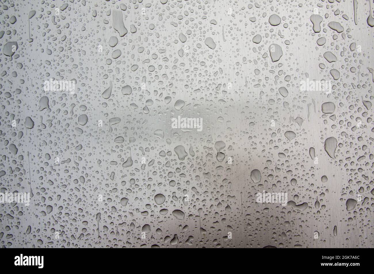 Abstract art texture background of raindrops on shiny brushed stainless ...