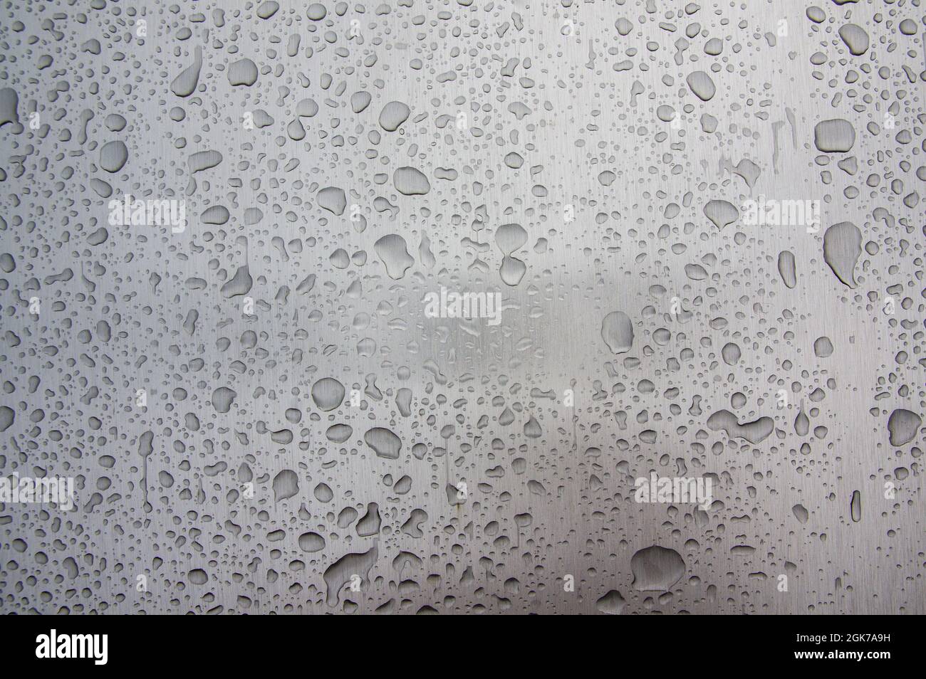 Abstract art texture background of raindrops on shiny brushed stainless ...