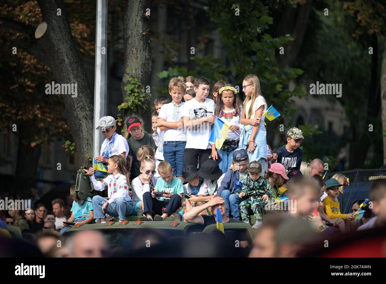 Ukrainian children watch the Independence Day parade from the top of a ...