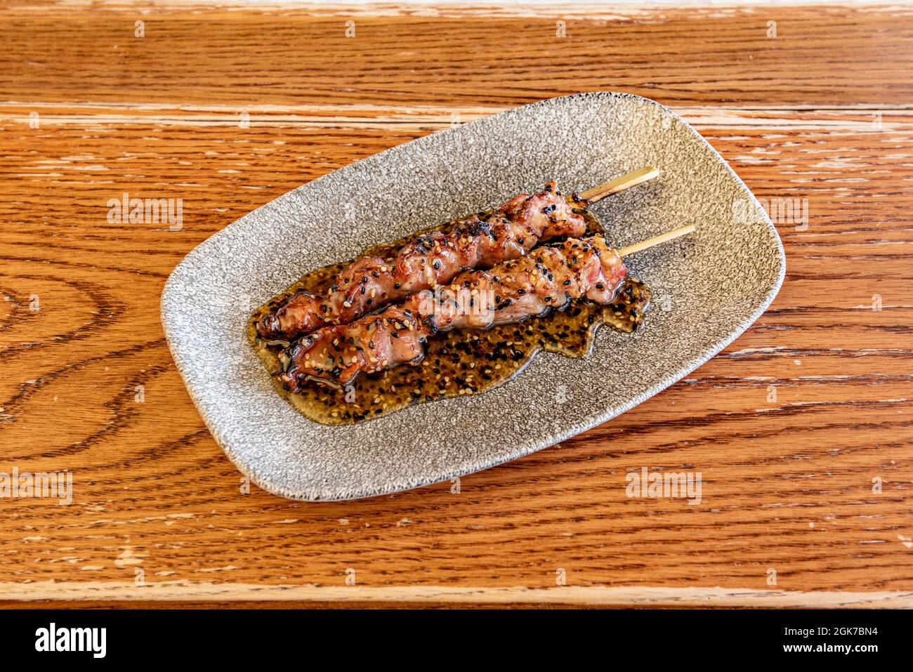 Iberian pork secret skewers grilled on charcoal with honey sauce and ... Iberian pork secret skewers grilled on charcoal with honey sauce and ...