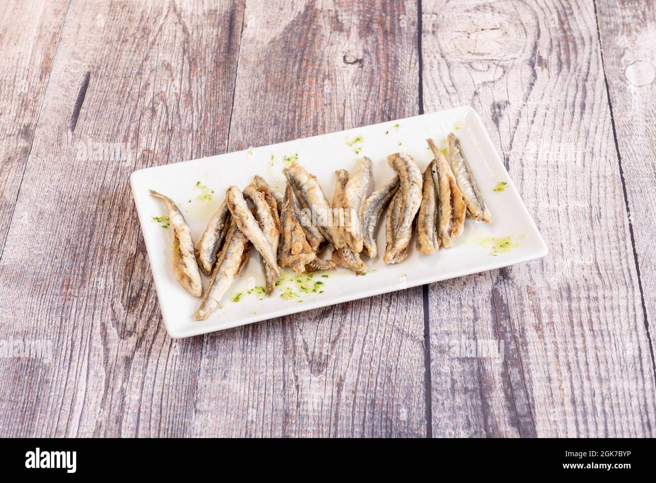 popular Spanish tapa tray of fried anchovies with wheat flour in olive ...