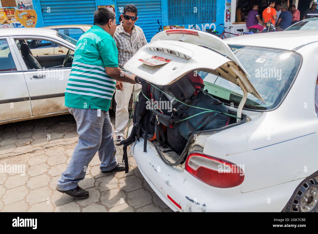 RIVAS, NICARAGUA - MAY 1, 2016: Taxi driver is securing oversize ...