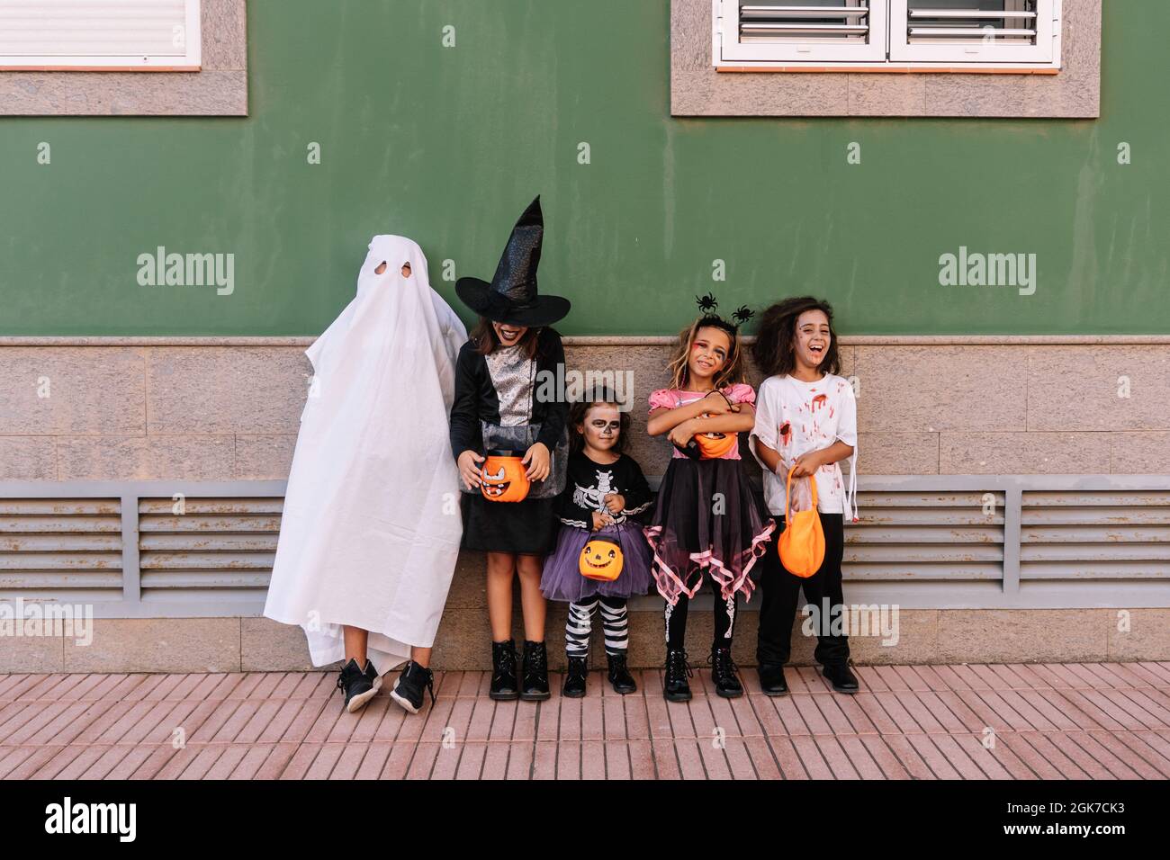 Portrait of a group of children dressed up for Halloween while doing ...