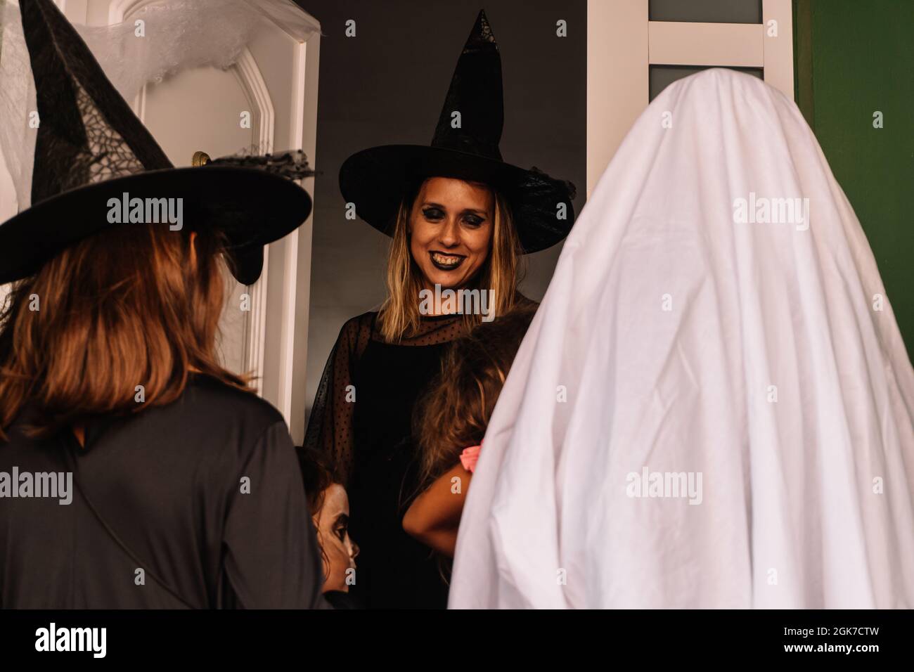 Woman giving candy to children hi-res stock photography and images - Alamy