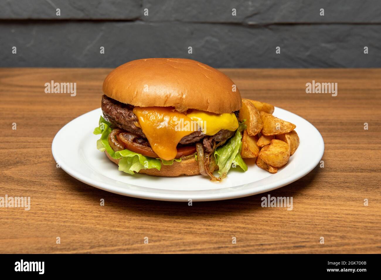 Beef burger with melted cheddar cheese, mustard, fried onion, tomato ...