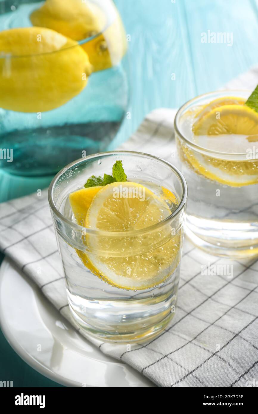 Composition with cold lemon water on wooden table, closeup Stock Photo ...