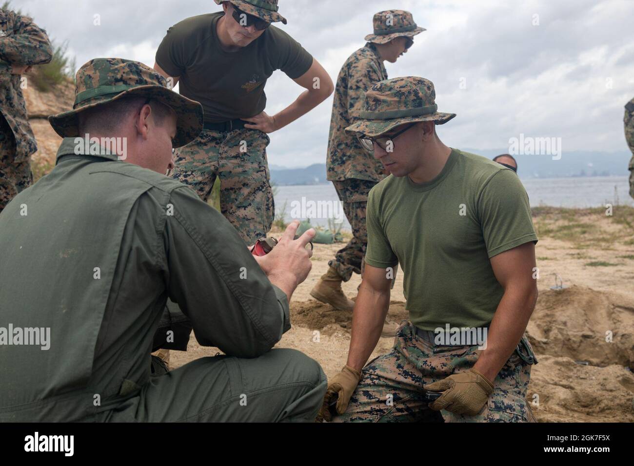 U.S. Marine Corps Chief Warrant Officer 4 Andrew Russell, left ...
