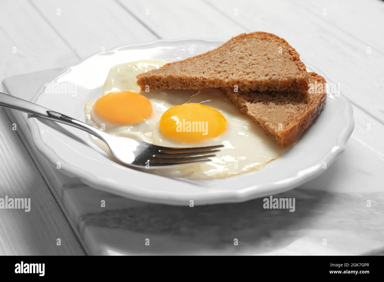 Delicious breakfast with over easy eggs on board Stock Photo - Alamy